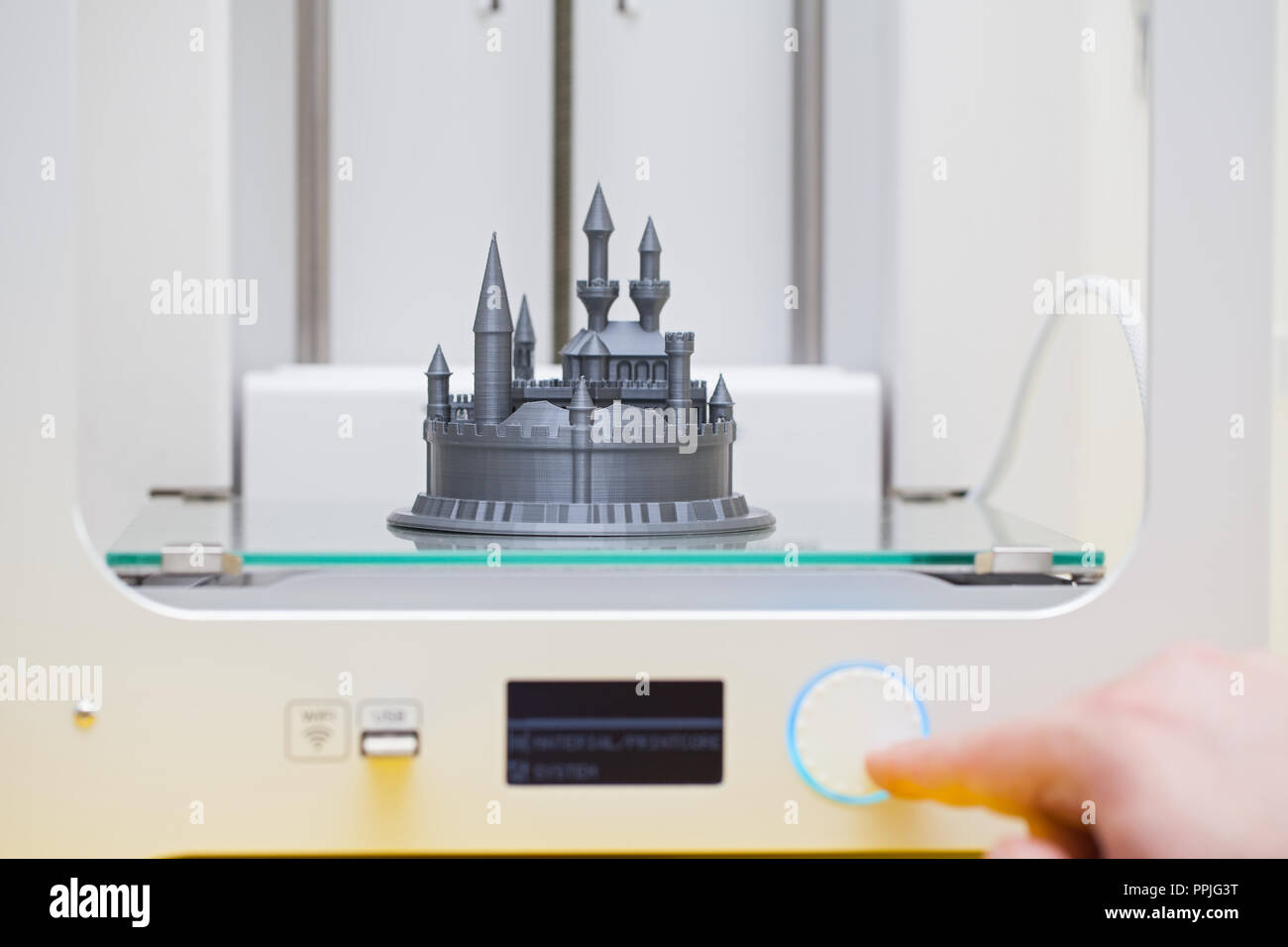 White 3D printer during work. Plastic castle - disney figure almoust ...