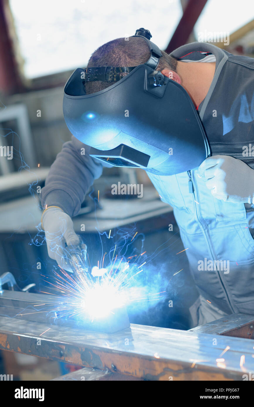 welder welding a material Stock Photo - Alamy