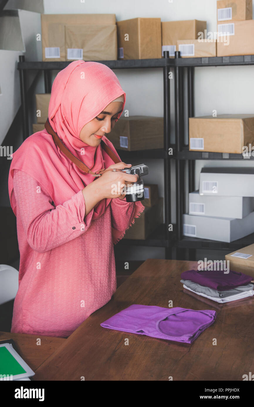woman online seller taking product picture Stock Photo - Alamy