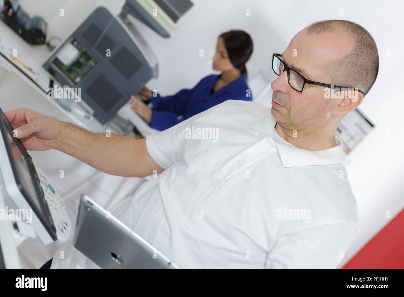 Technician using tablet analysing hi-res stock photography and images ...