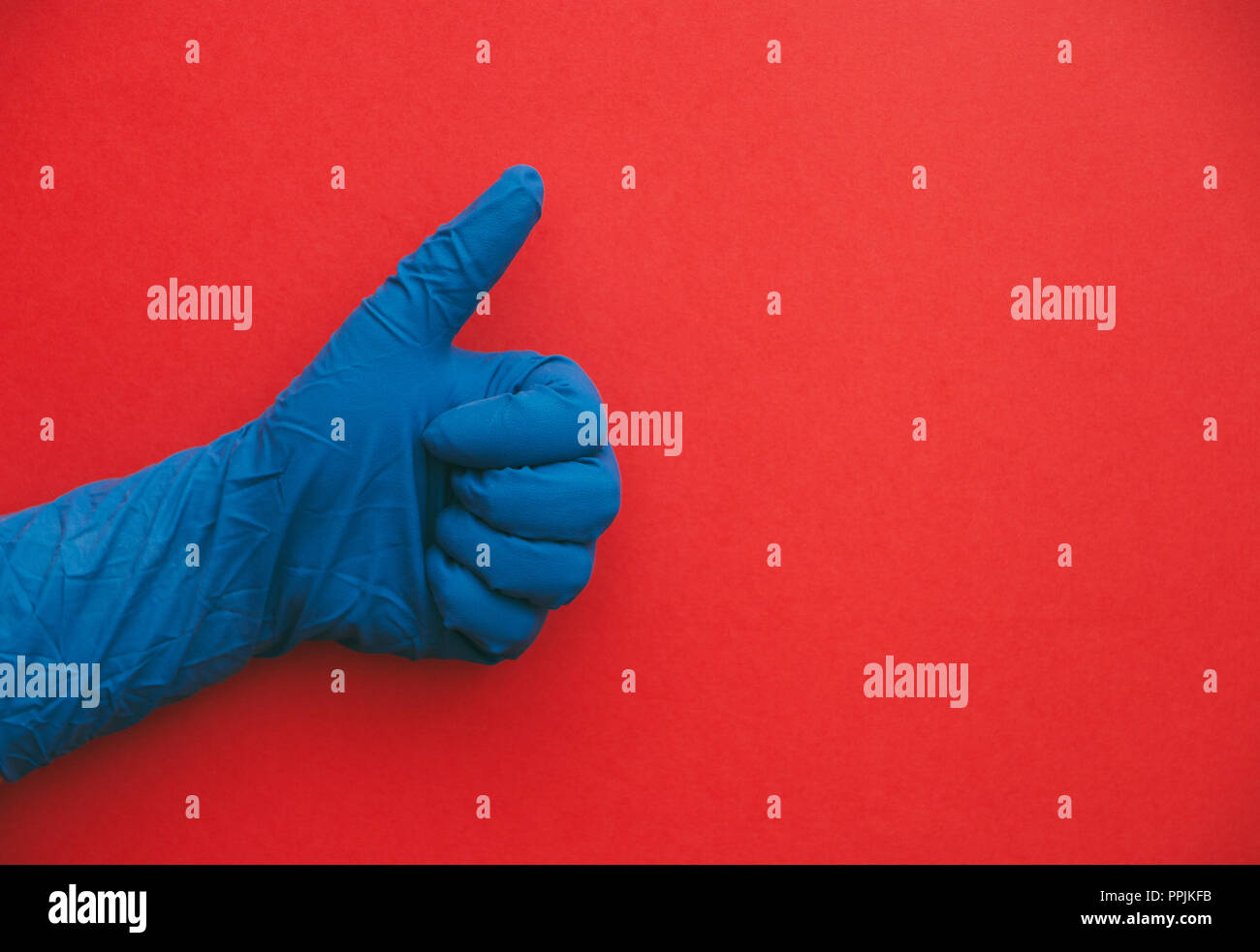 insulated hand in blue glove with positive sign and approval Stock ...