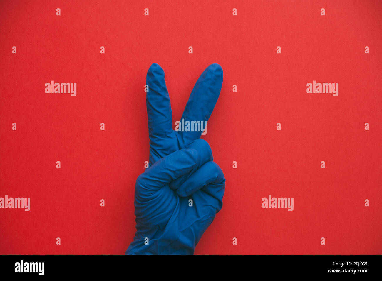 insulated hand in blue glove hand gesture as two or peace sign Stock ...