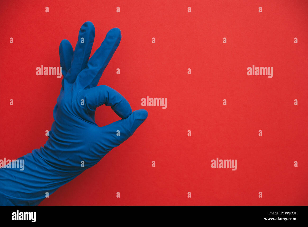insulated hand in blue glove with positive sign and approval Stock ...