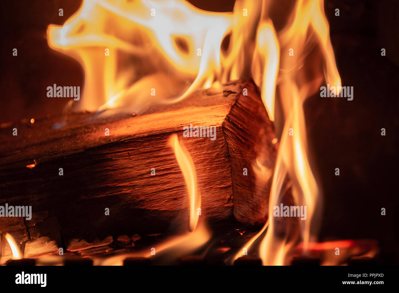 Hardwood logs on fire inside a woodburning stove Stock Photo - Alamy