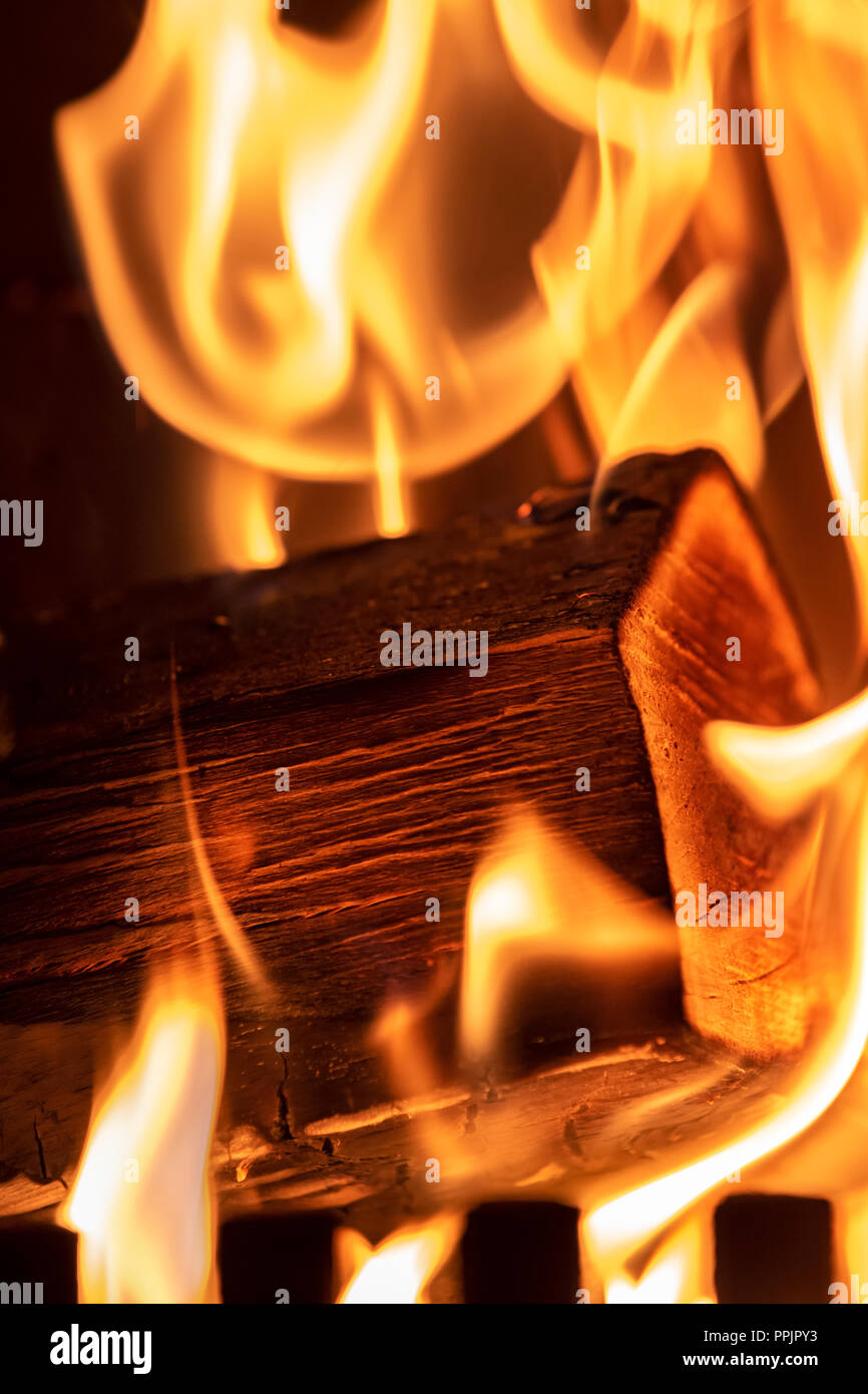 Hardwood logs on fire inside a woodburning stove Stock Photo - Alamy
