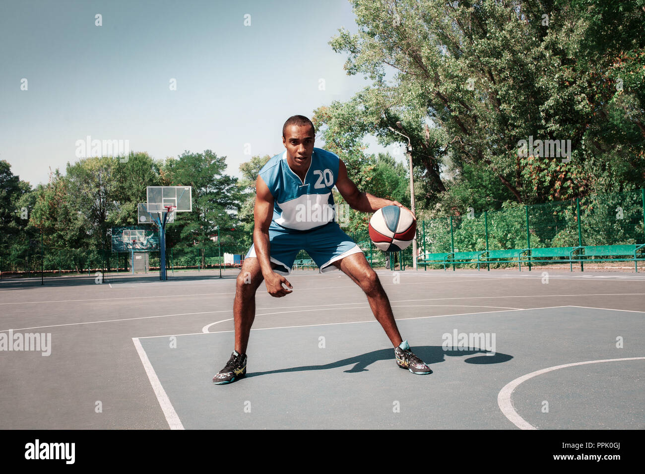 Picture of young confused african basketball player practicing outdoor ...
