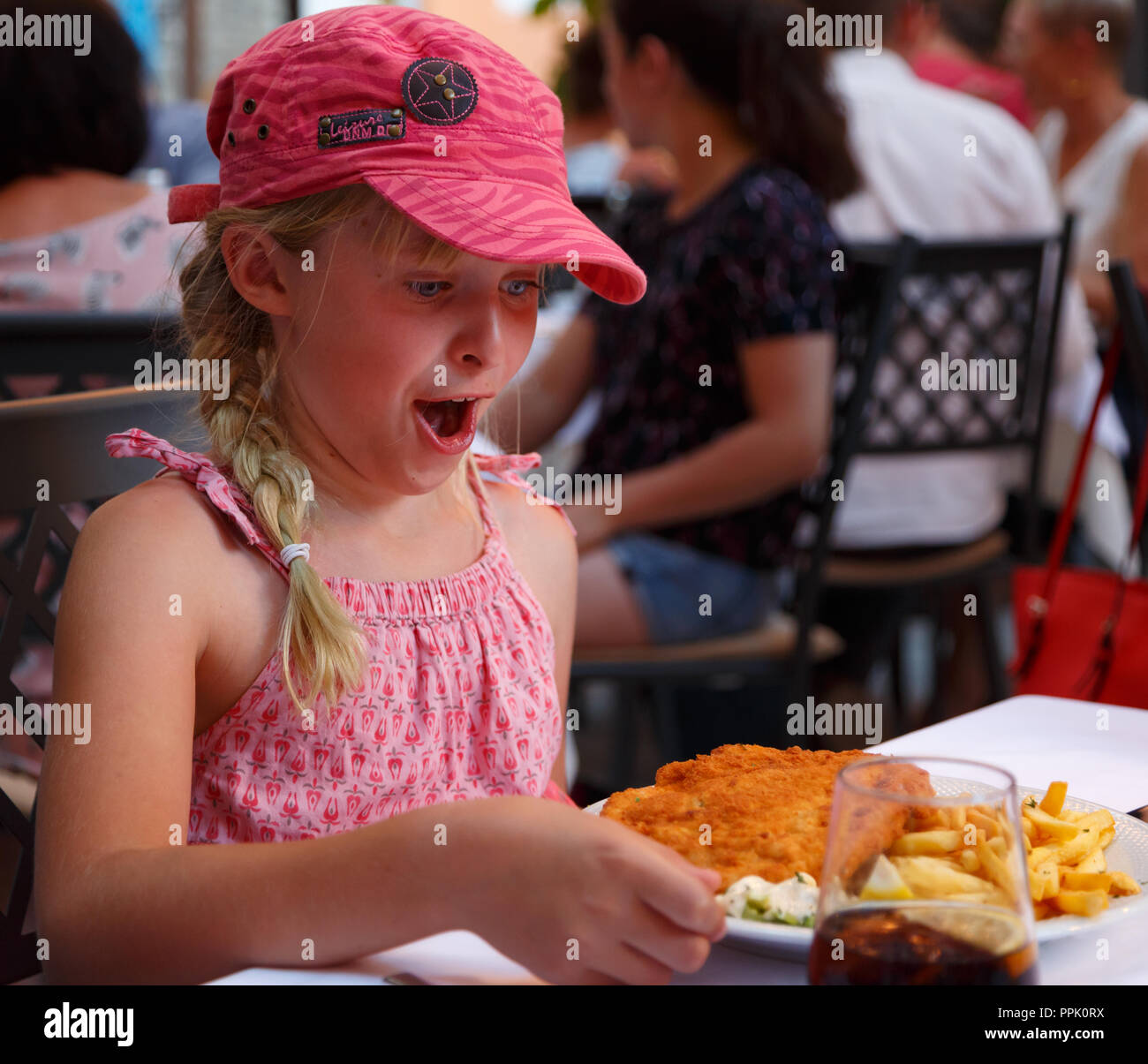 Young girl surprised of big plate of food Stock Photo - Alamy