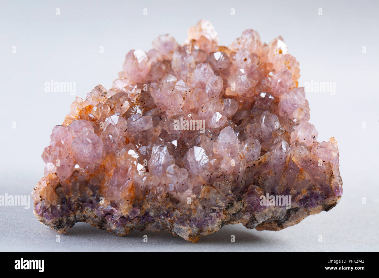 Natural Druse of amethyst on a white background stone Stock Photo - Alamy