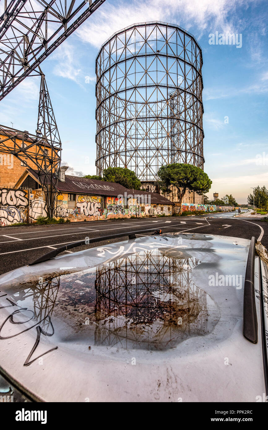 The Gazometer of Rome, in Ostiense quarter, reflecting over a roof of a ...