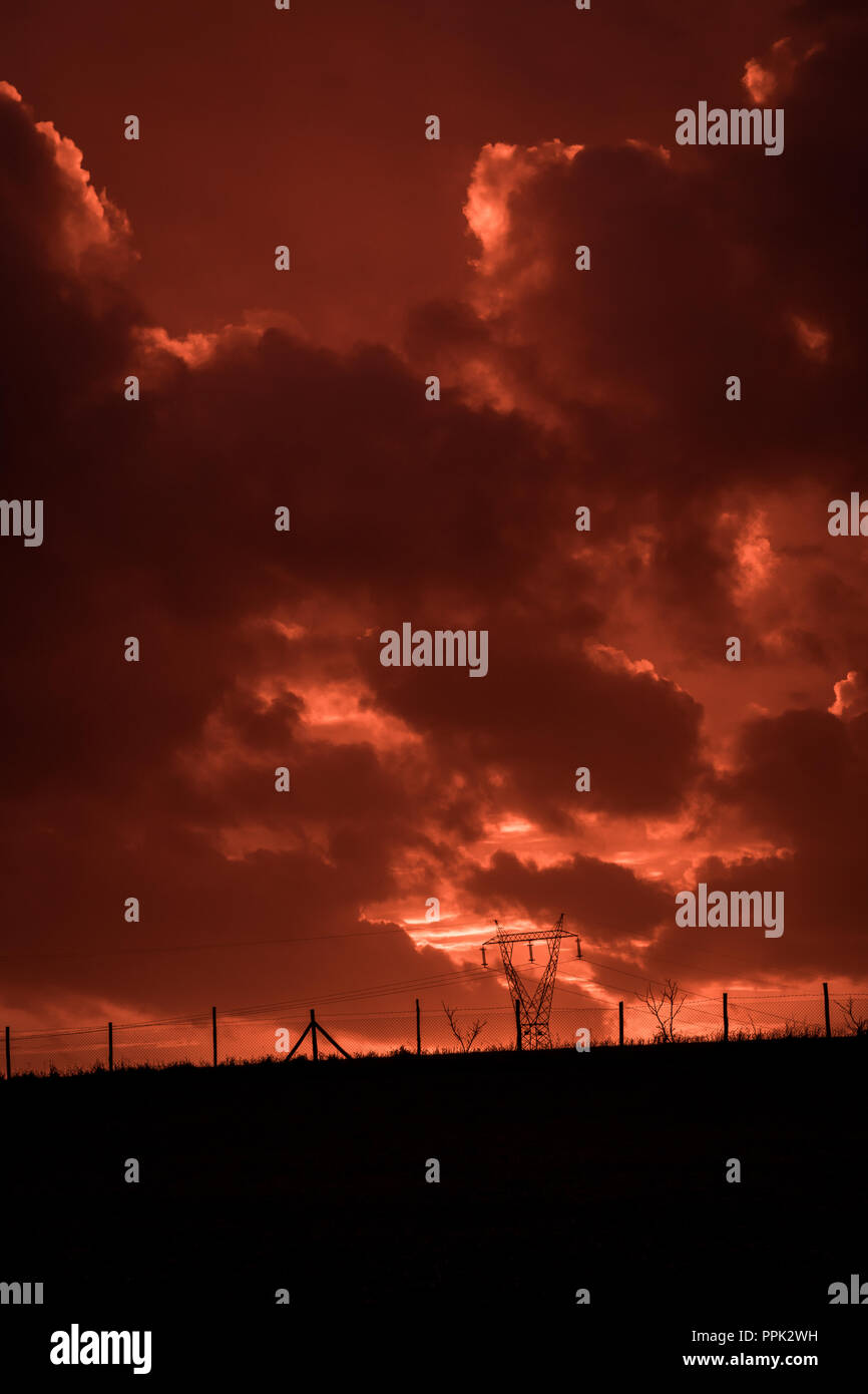 Cinematic horror scenario, deep red sky, with massive black clouds ...