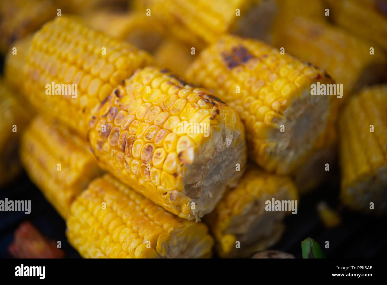 BBQ'd bright yellow cooked sweetcorn on the cob in a stack Stock Photo ...