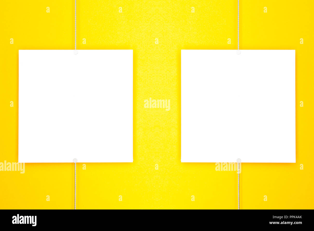 Paper cards (photo frame) hanging on metal rope with magnets on yellow ...