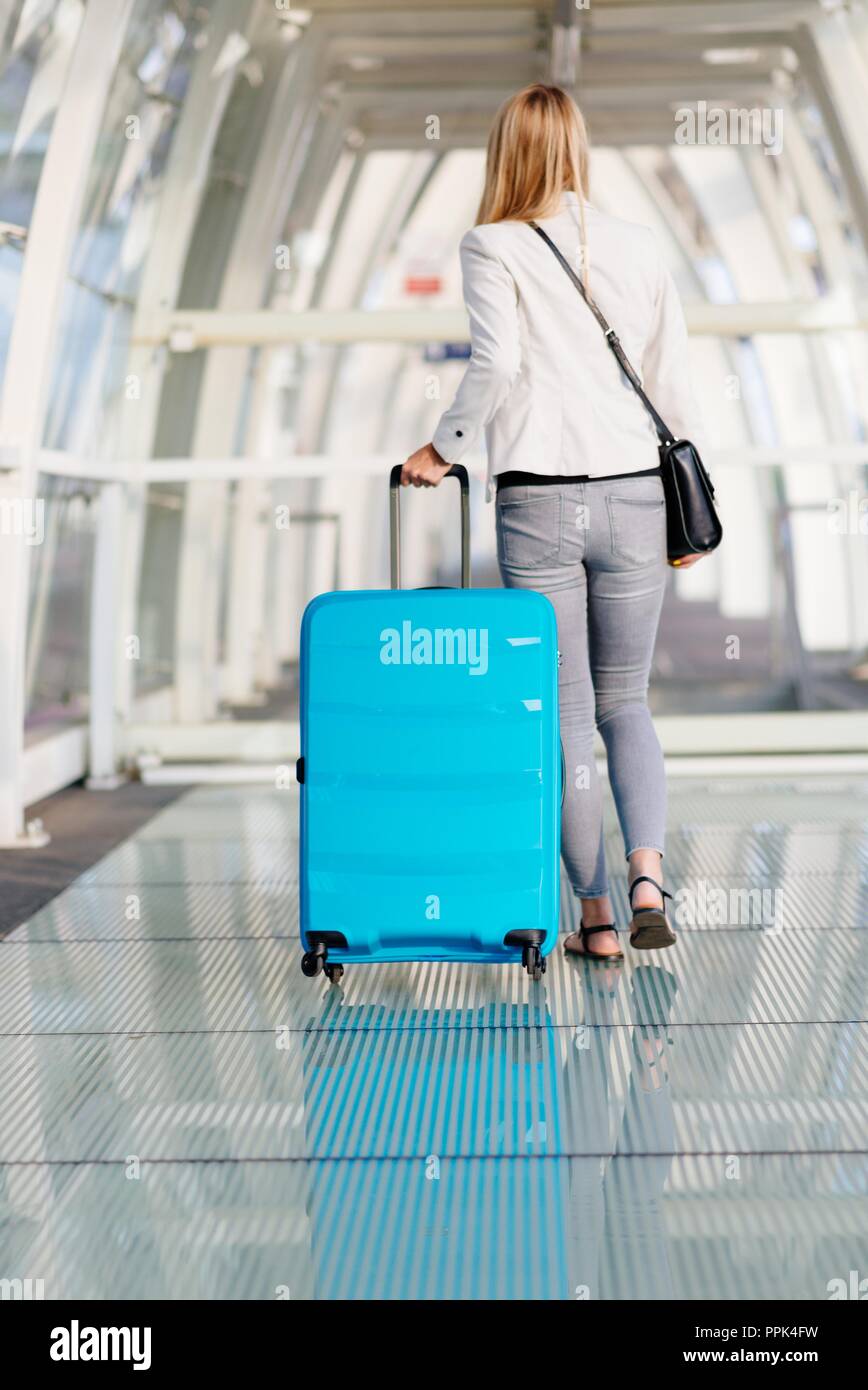 Woman with her baggage on airport terminal. Business trip Stock Photo ...