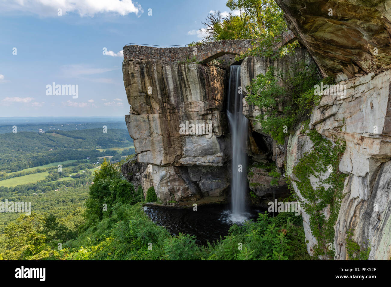 Cliffside Waterfall Under Footbridge Stock Photo - Alamy
