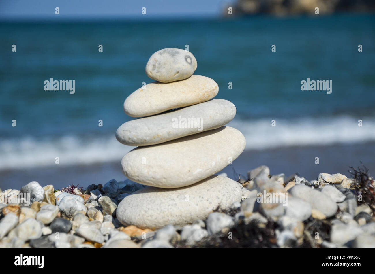 Stack of stones on the beach in summer Stock Photo - Alamy