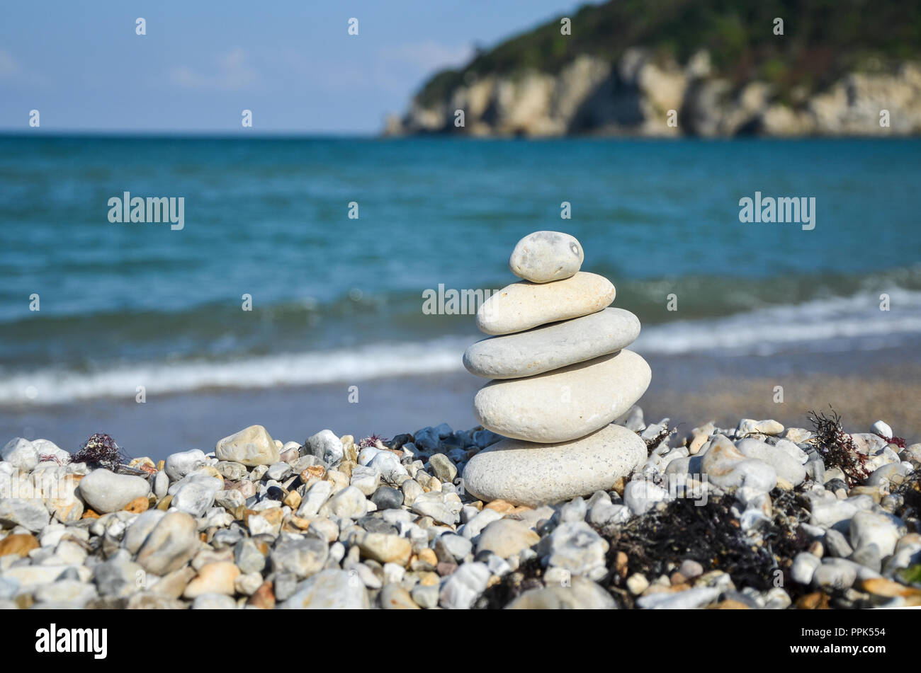 Stack of stones on the beach in summer Stock Photo - Alamy
