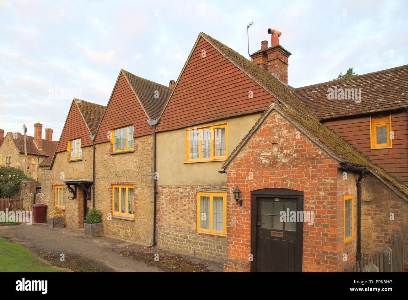 traditional yellow window frames of houses within cowdray park and ...