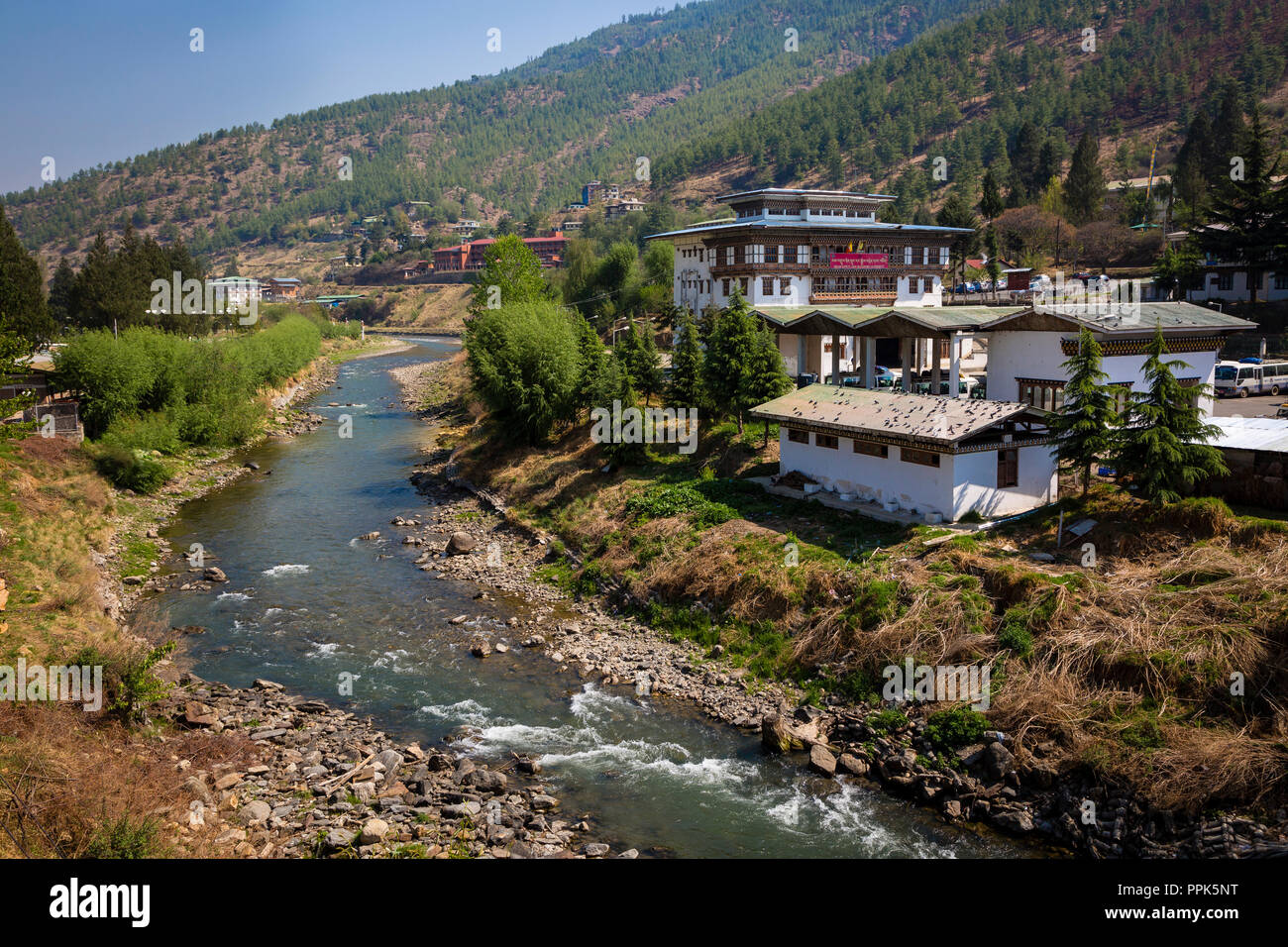 View of a river with backdrop of local houses in the countryside of the ...