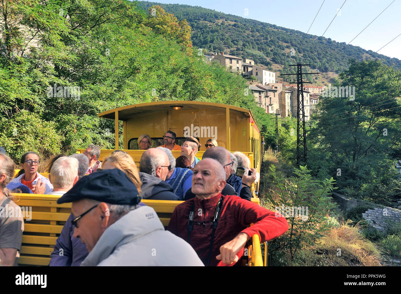 The travelers of the little yellow train of the Pyrenees in the wagon ...