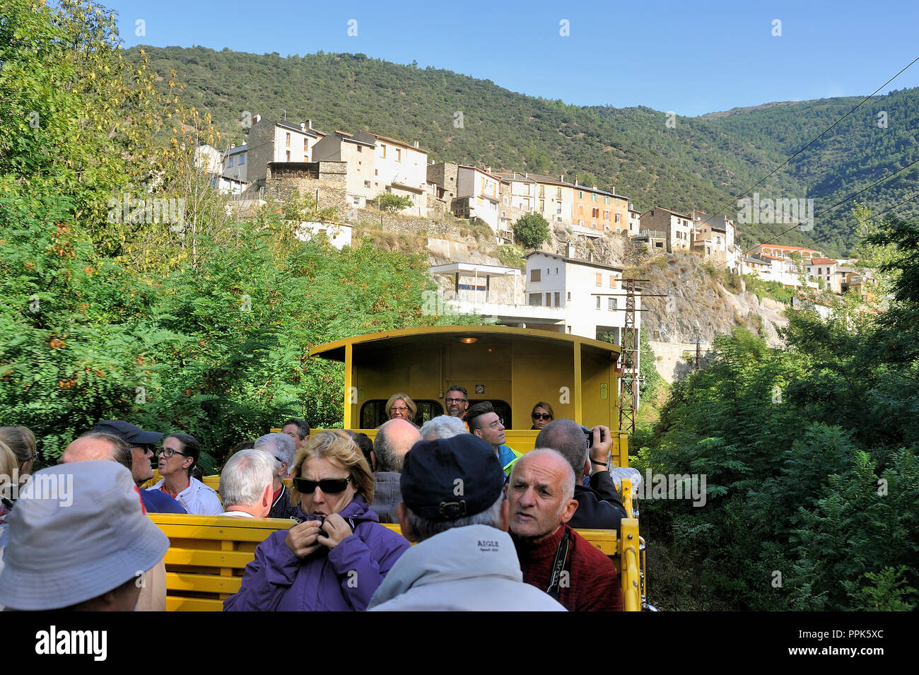 The travelers of the little yellow train of the Pyrenees in the wagon ...