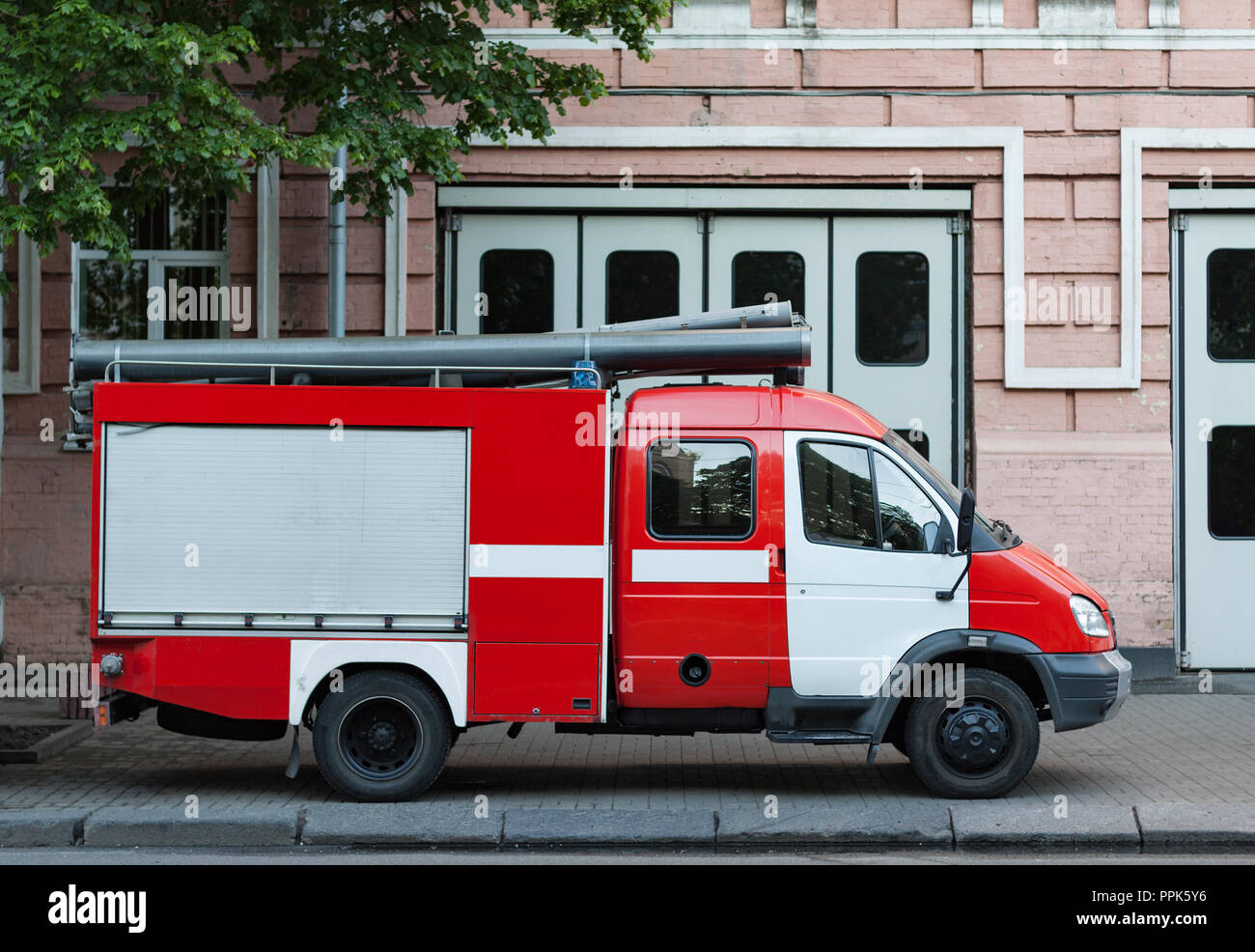 Fire truck near the gate of fire station Stock Photo - Alamy