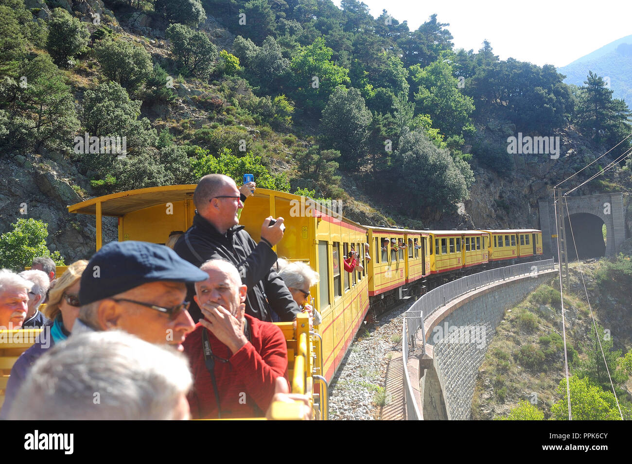The travelers of the little yellow train of the Pyrenees in the wagon ...