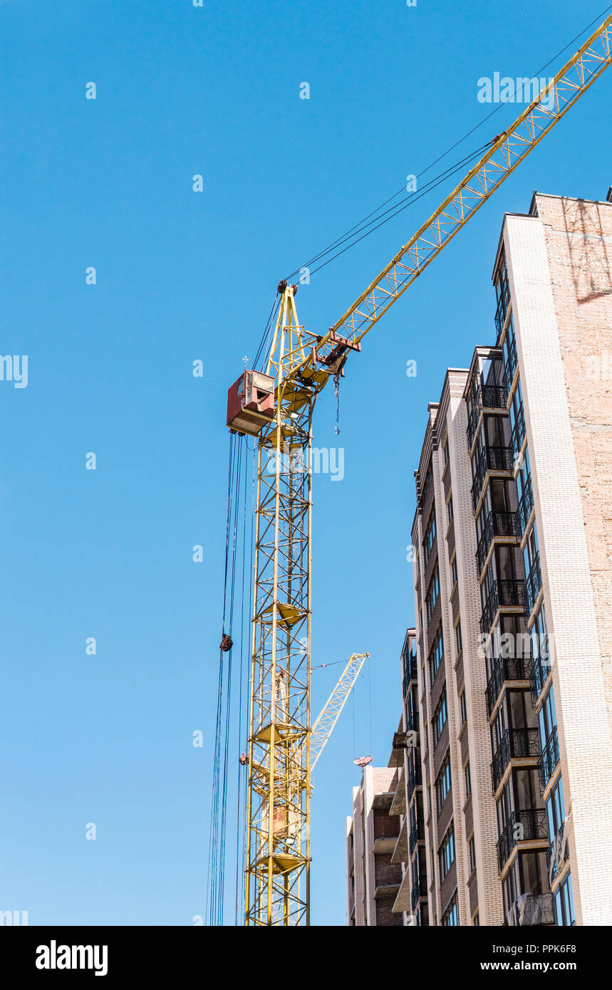 Construction of a high-rise building with a crane. Building ...