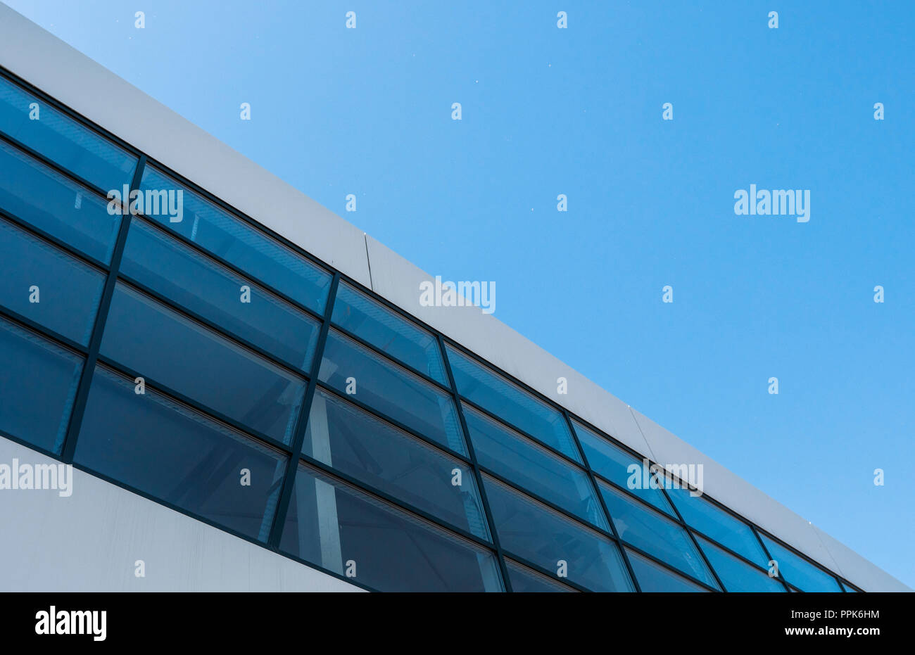 Building with white aluminum facade with windows and aluminum panels ...