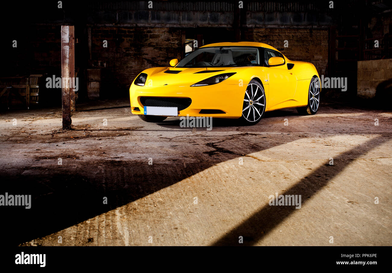 Bright yellow Lotus Evora in a farmyard in the Cotswolds, England, UK ...