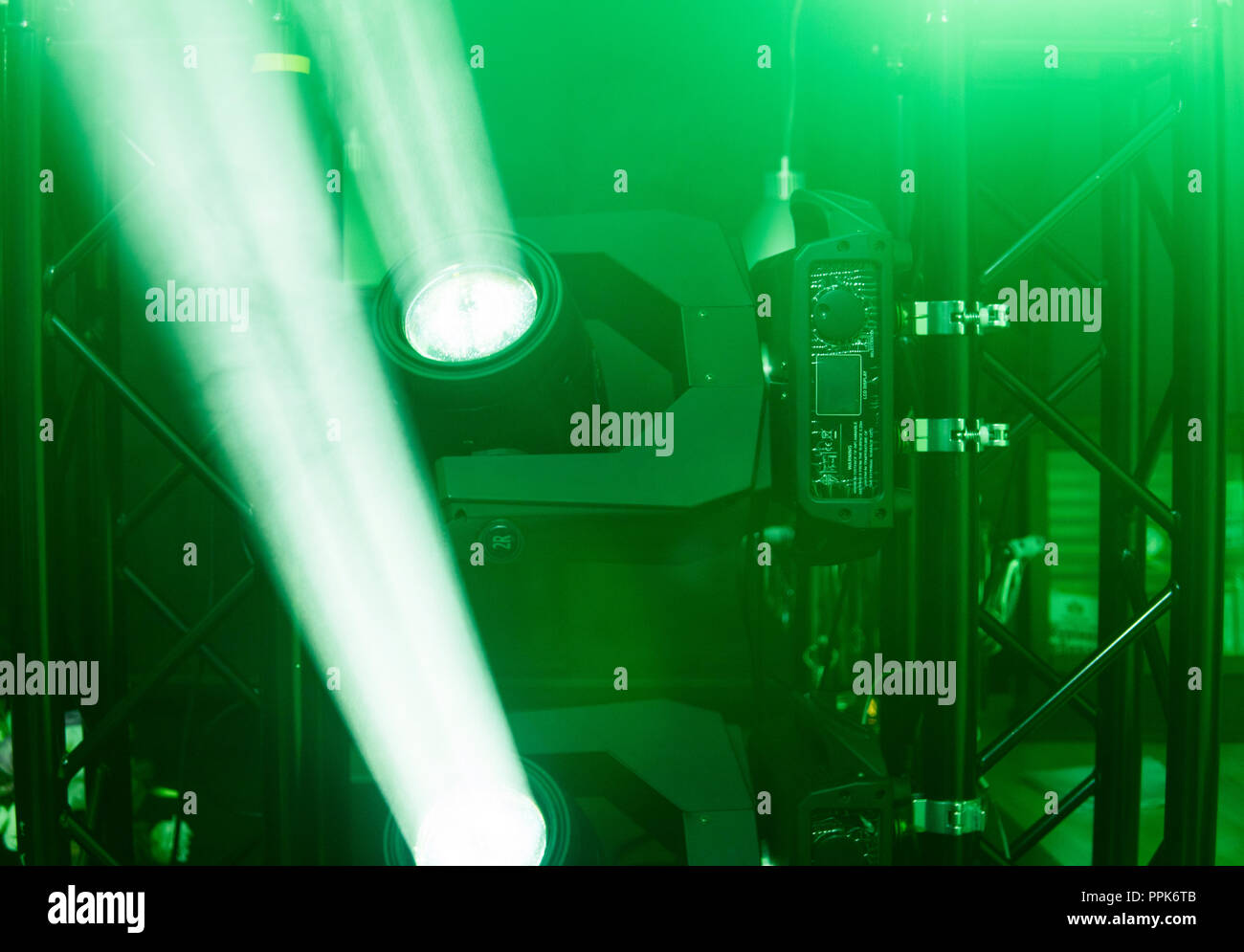 Switched on stage lights under the green light. Light moving head for ...