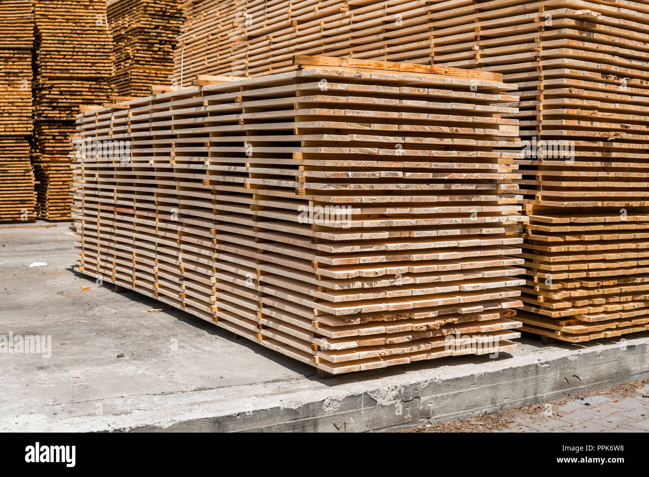 Piles of wooden boards in the sawmill, planking. Warehouse for sawing ...