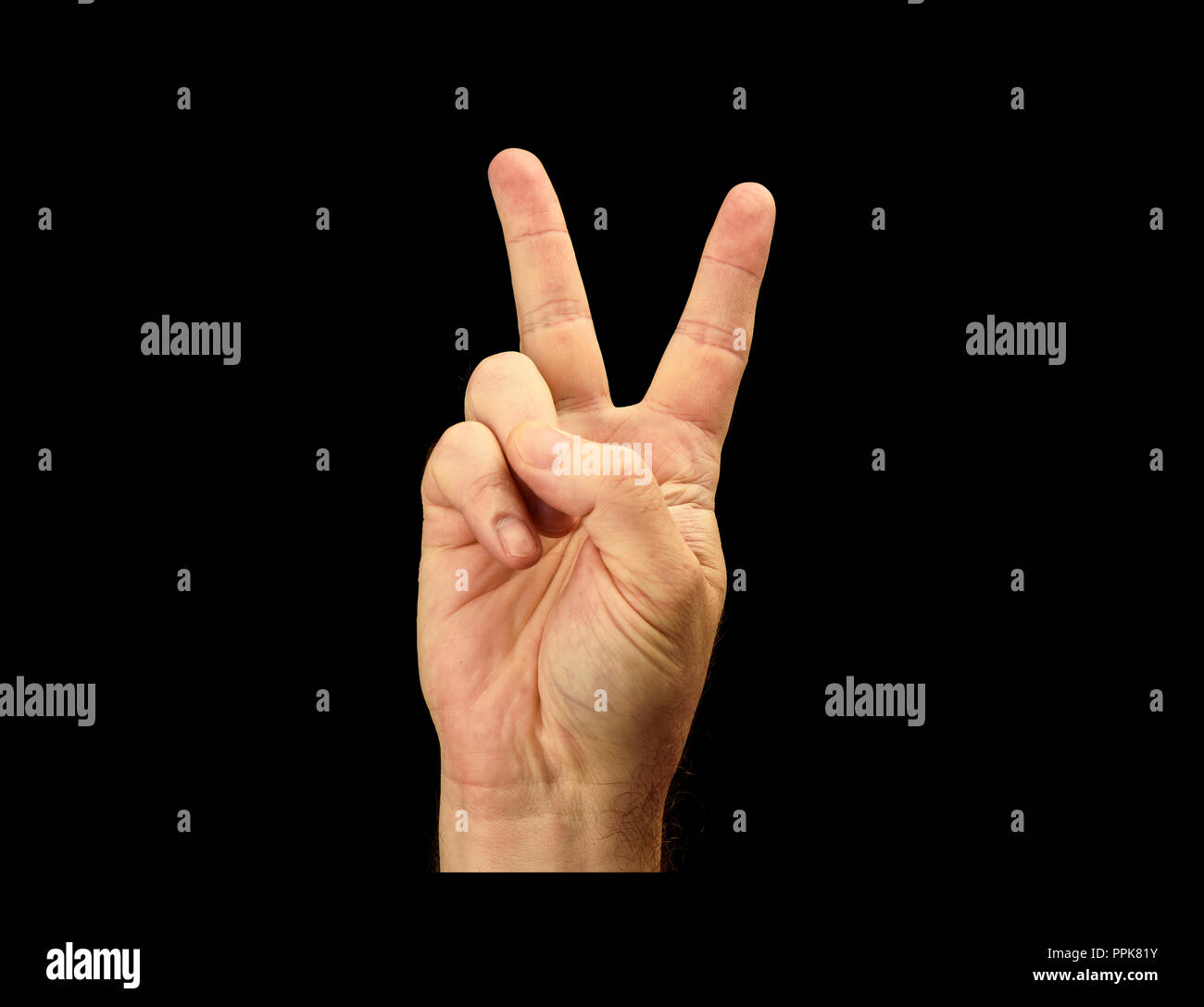 Male hand showing the Victory sign, isolated on black background Stock ...