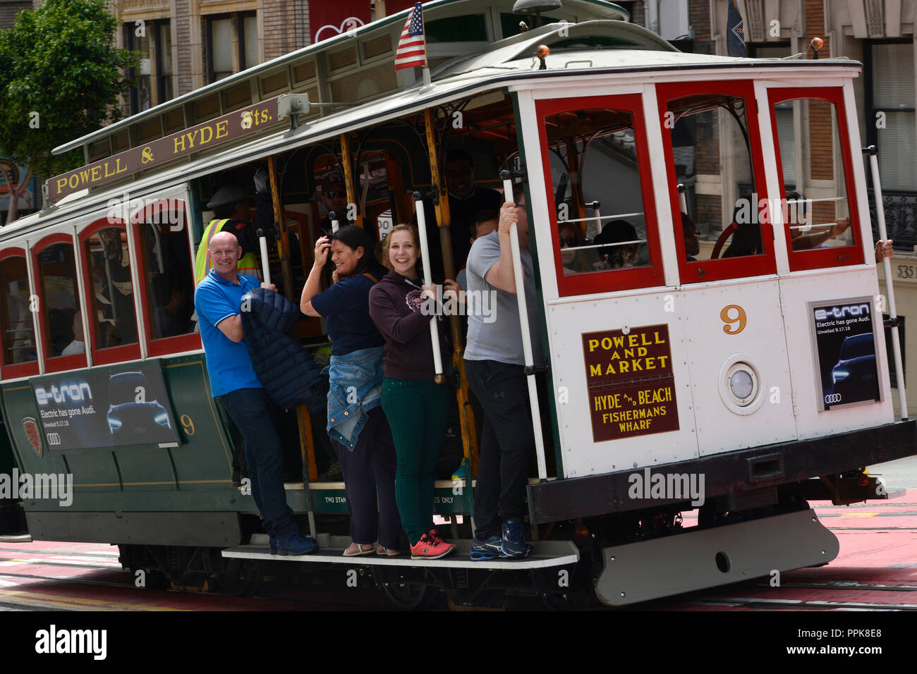 Tourists riding a cable car in San Francisco, California USA Stock ...