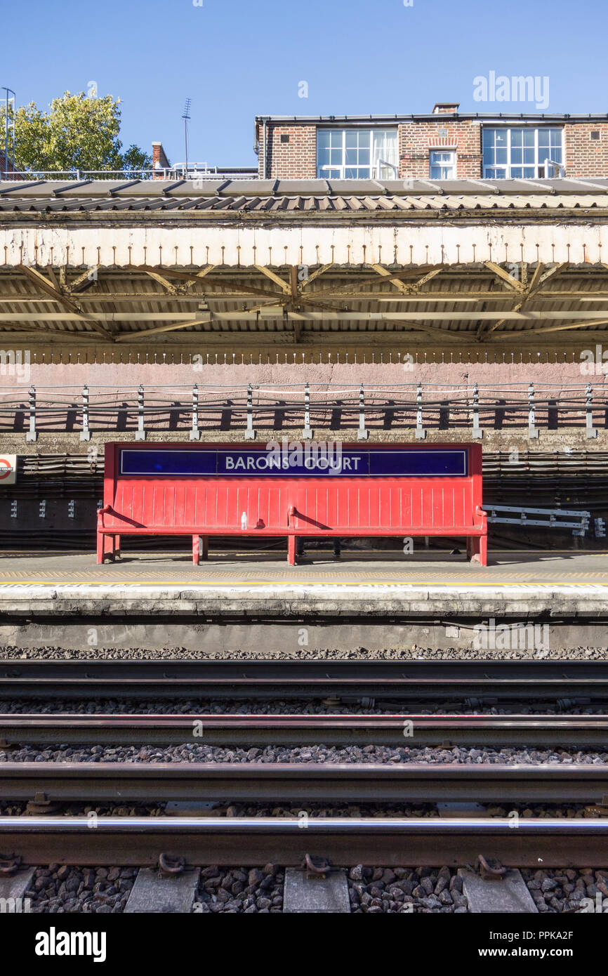 An old wooden platform bench on Barons Court underground station ...