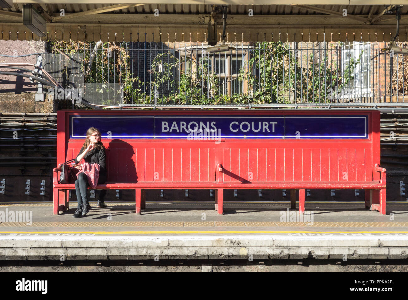 An old wooden platform bench on Barons Court underground station ...