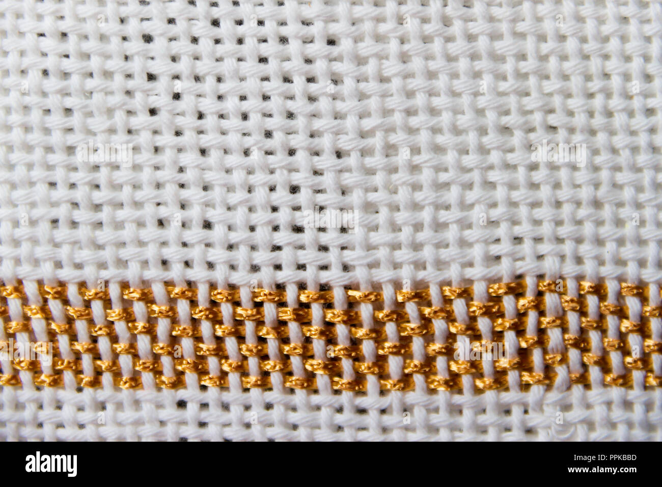 Textures of loom-woven threads in white tones with golden edges Stock ...