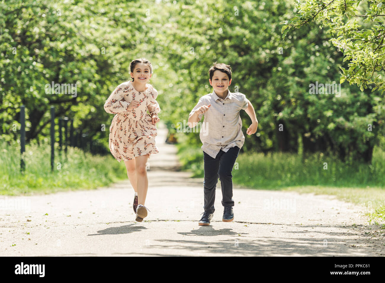 happy kids having fun and running in summer park Stock Photo - Alamy