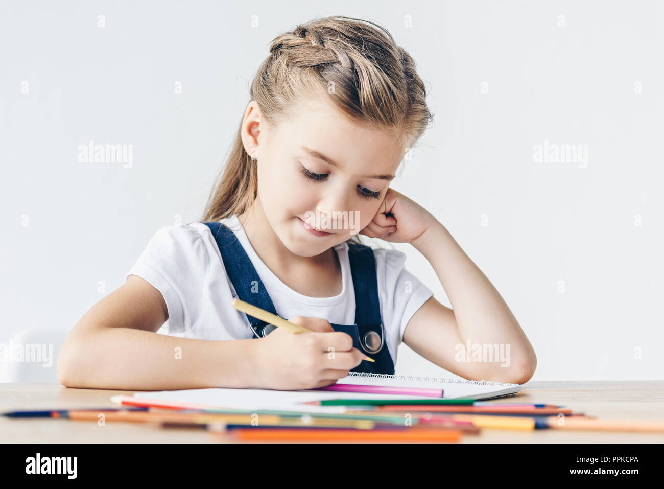 beautiful little child drawing with color pencils isolated on white ...