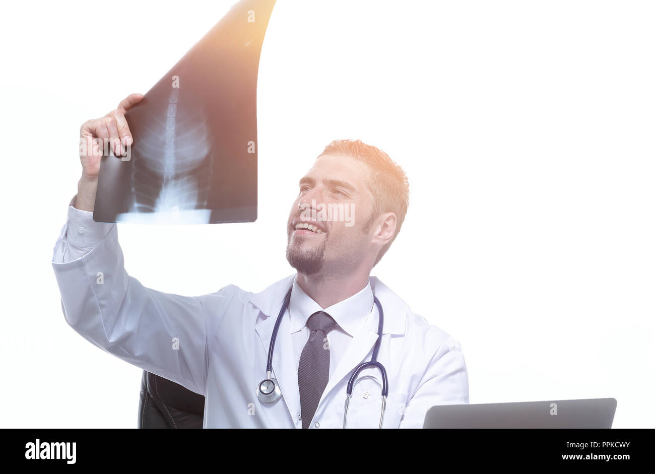 doctor examines an x-ray,sitting behind a Desk Stock Photo - Alamy