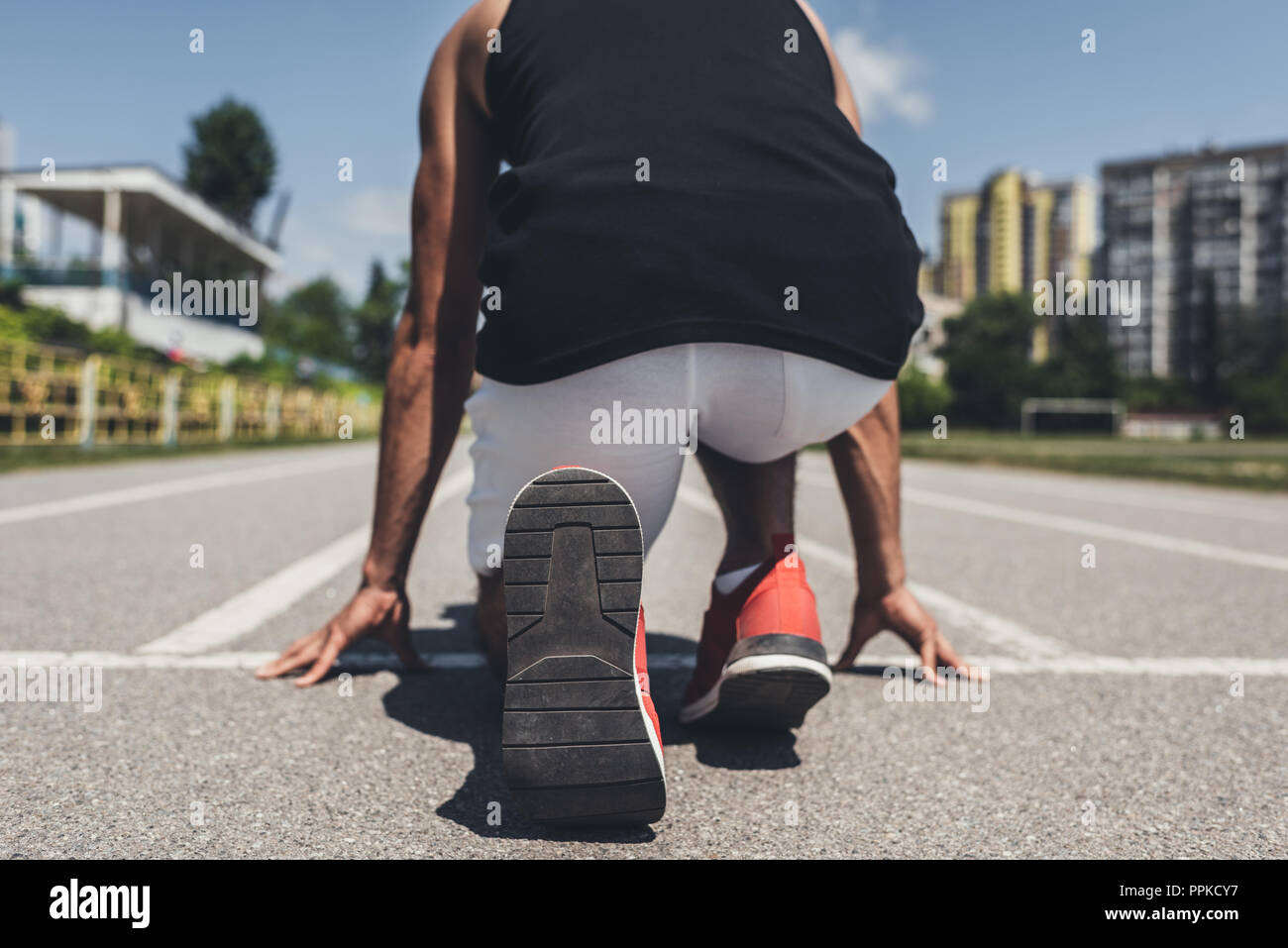 back view of male athlete in starting position on running track Stock ...