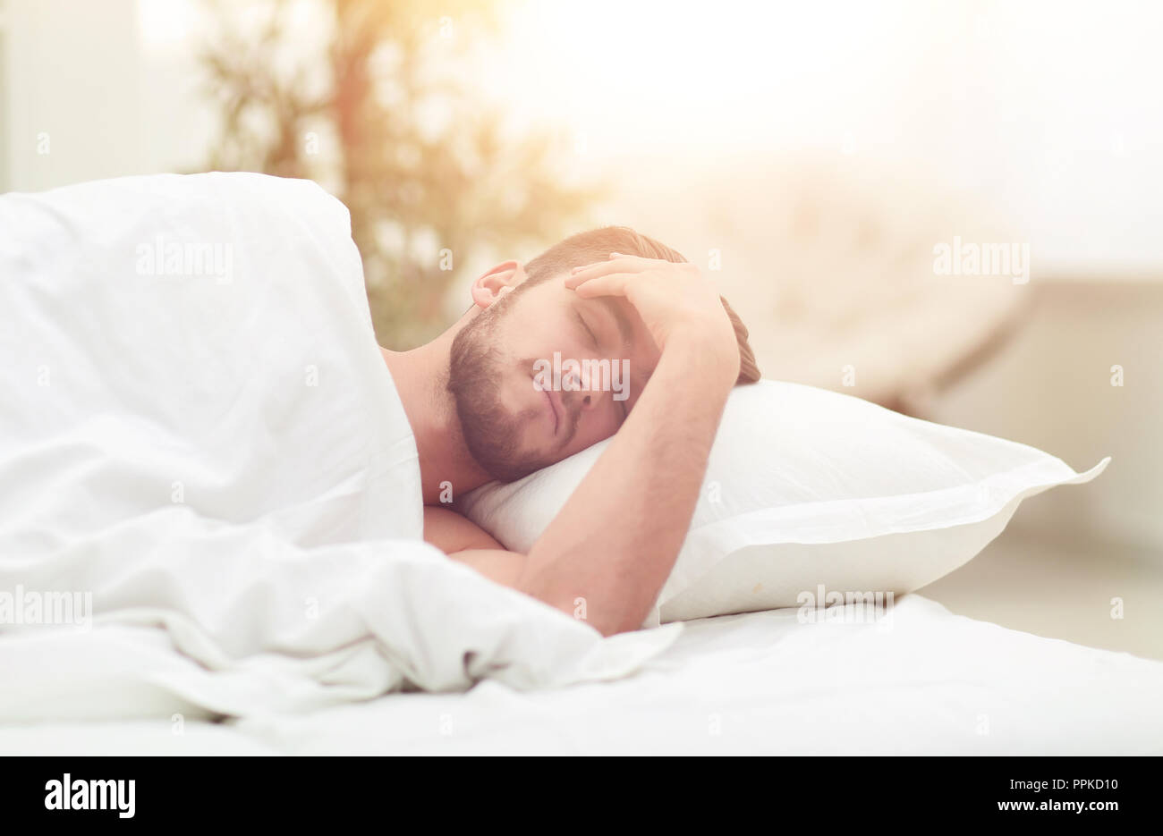 young man is sleeping in a comfortable hotel room Stock Photo - Alamy