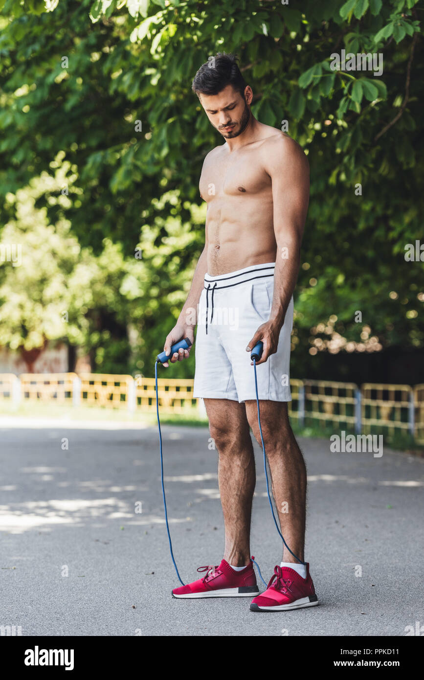 handsome shirtless young man with jumping rope Stock Photo - Alamy