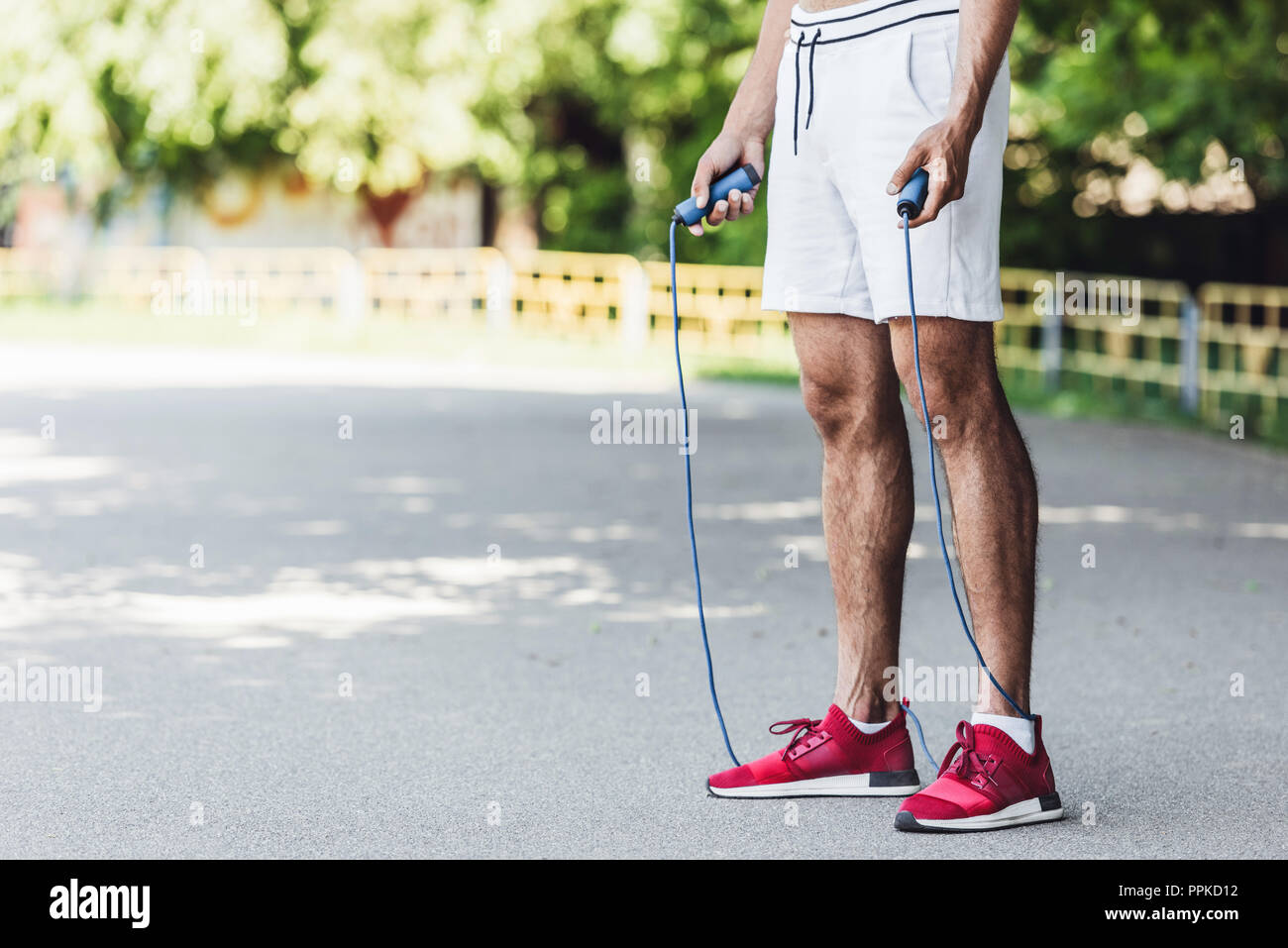 cropped shot of sportive young man with jumping rope Stock Photo - Alamy