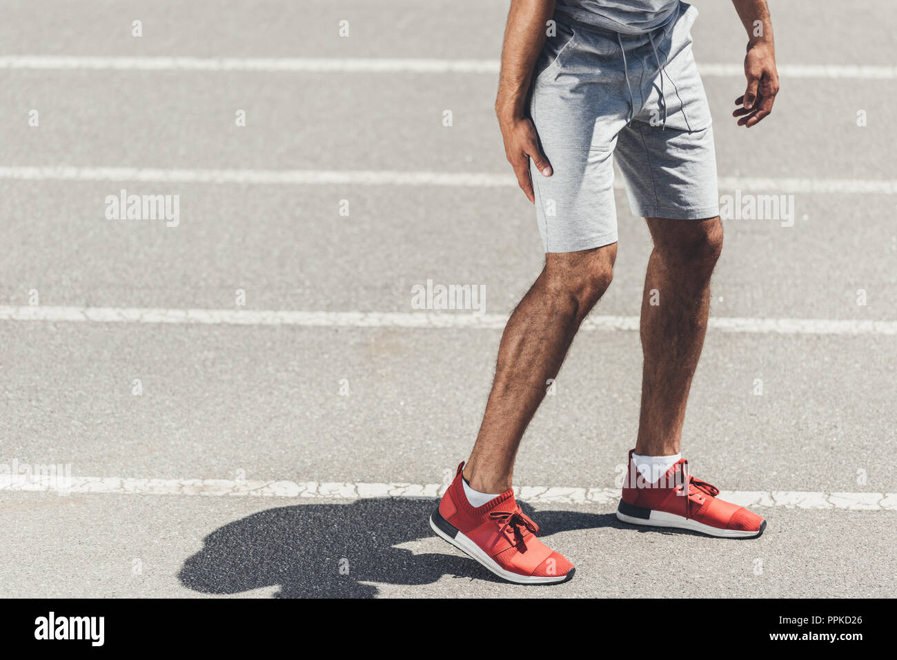 cropped shot of runner with leg injury on running track Stock Photo - Alamy