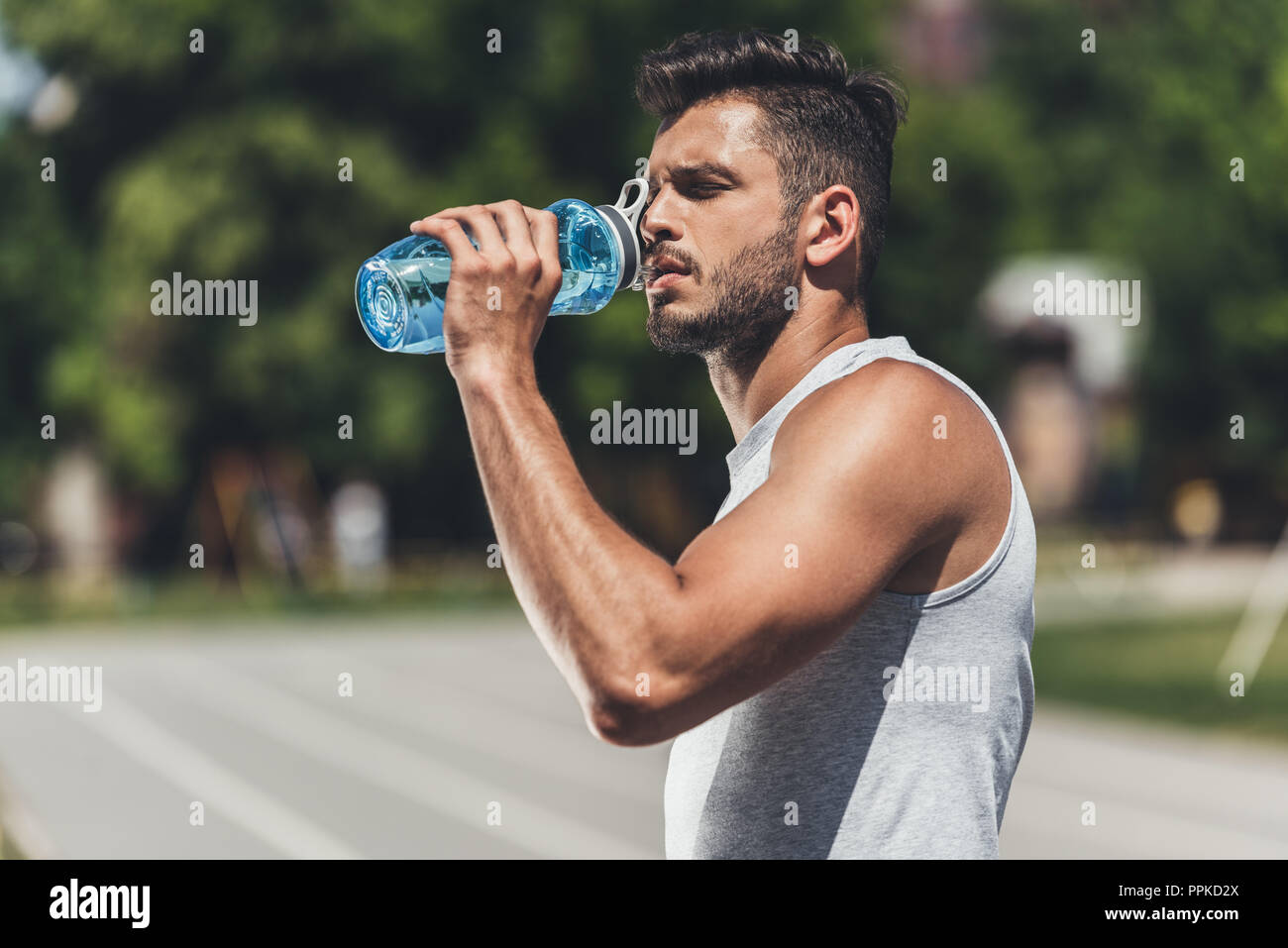 Young man drinking water after hi-res stock photography and images - Alamy