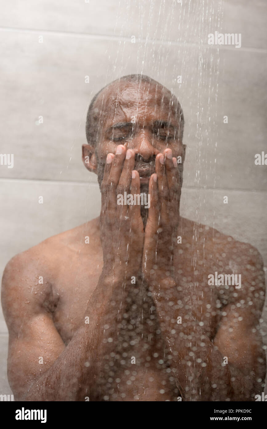 handsome african american man washing body in shower Stock Photo - Alamy