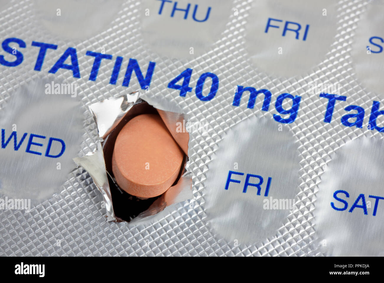 A statin tablet emerging from a marked weekly blister pack Stock Photo ...