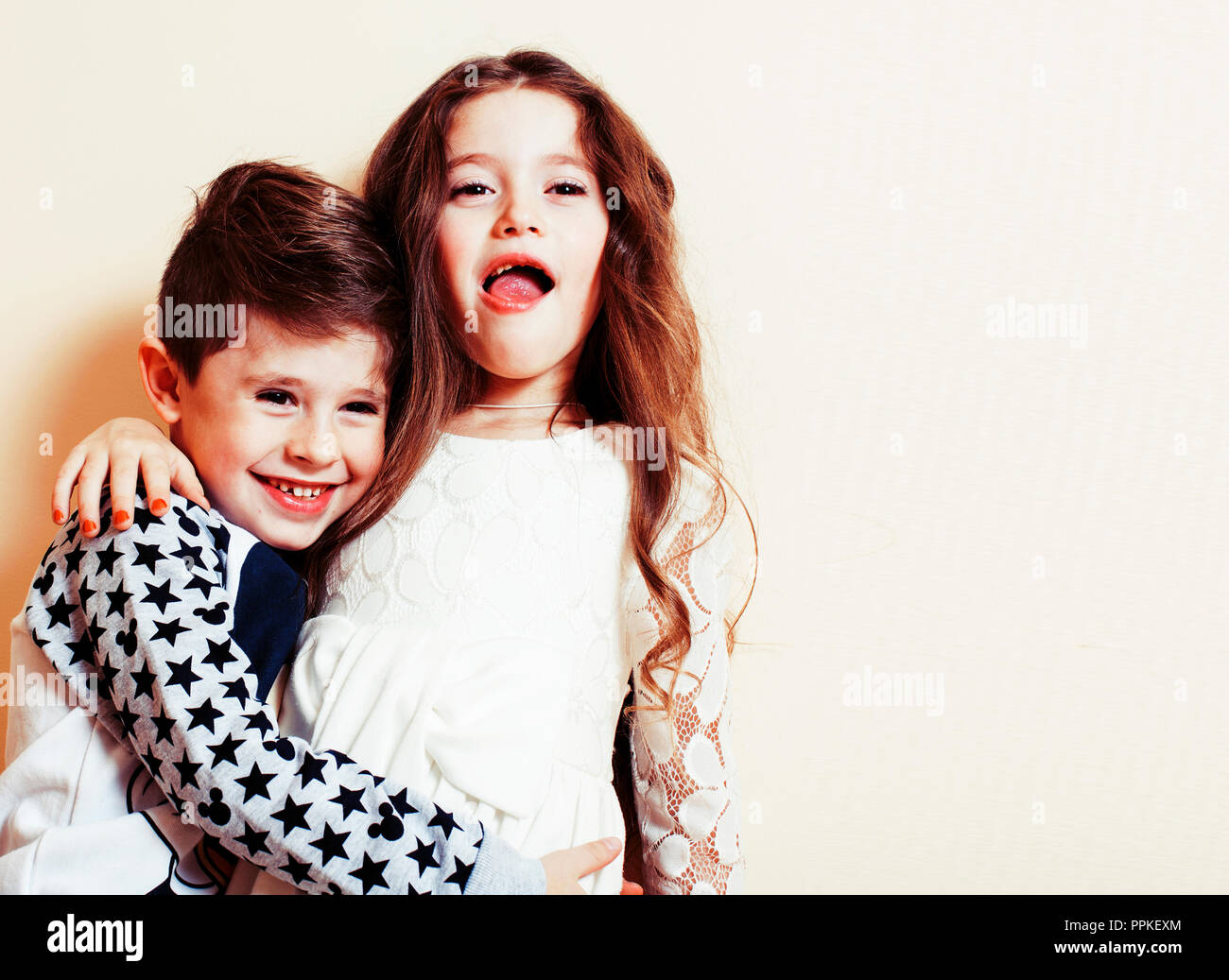 little cute boy and girl hugging playing on white background, ha Stock Photo - Alamy