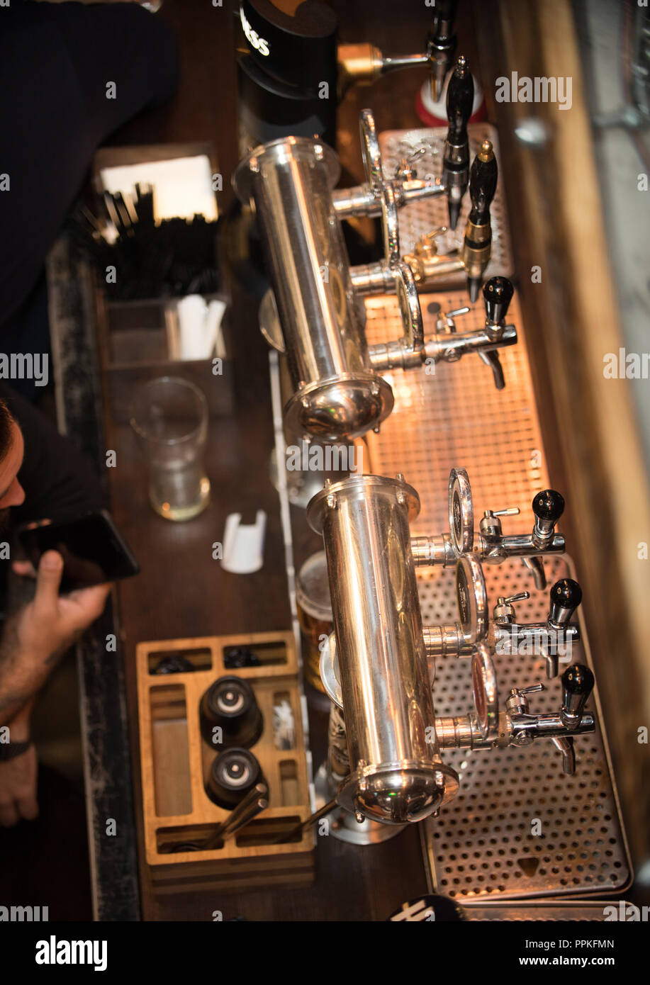 View of the bar with beer taps and bartenders' hands. Close up Stock ...