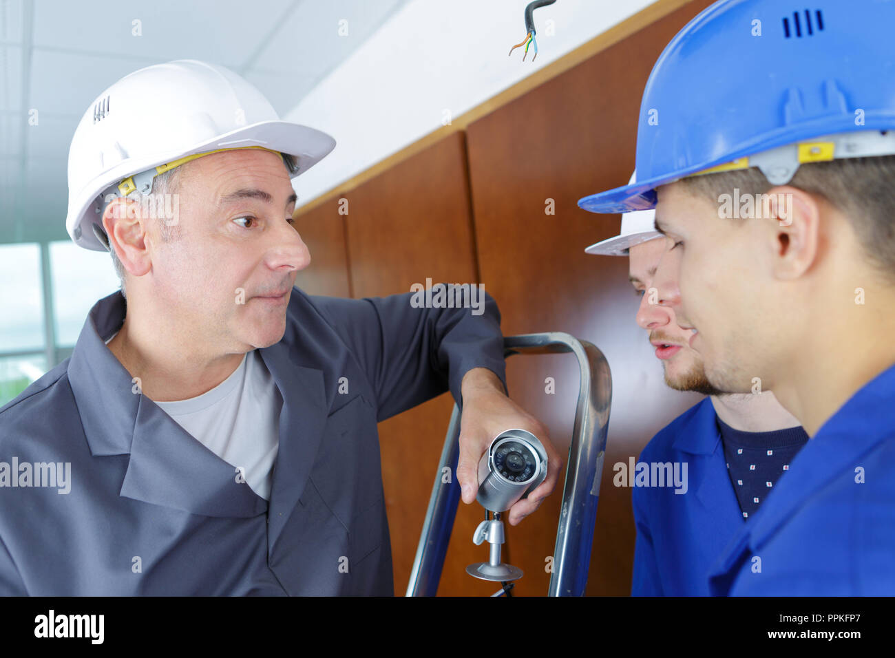 technician telling students how to installing video surveillance camera ...